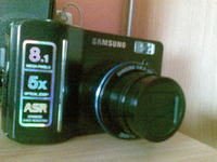 Samsung S850 - Jak naprawić zablokowaną osłonę obiektywu?